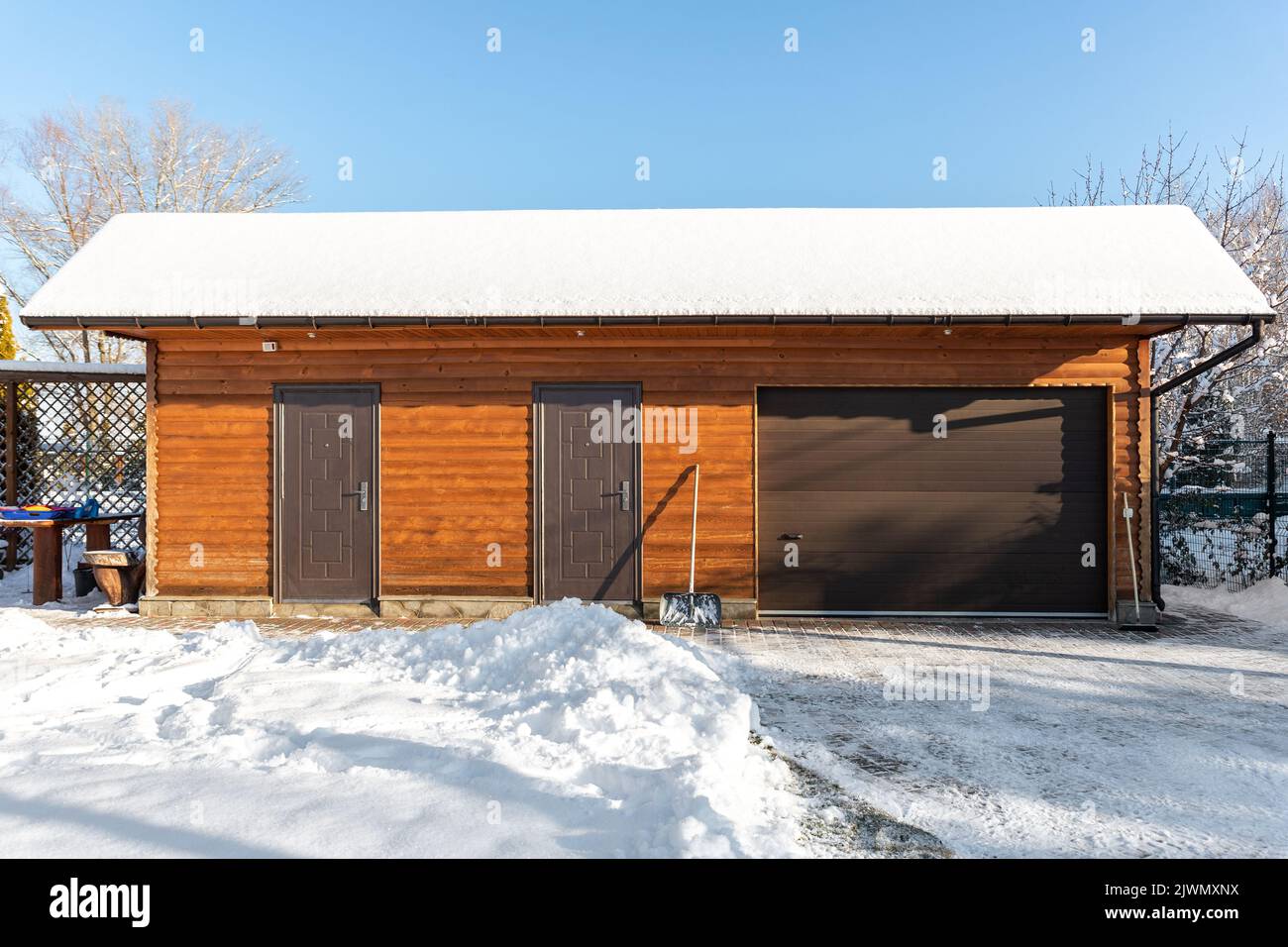 Facade front wall view closed door ATV home garage workshop clutter shed storage warehouse ...