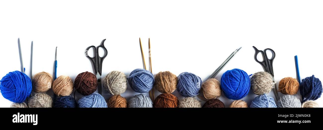 Blue, gray and brown balls of knitting thread with scissors, crochet ...