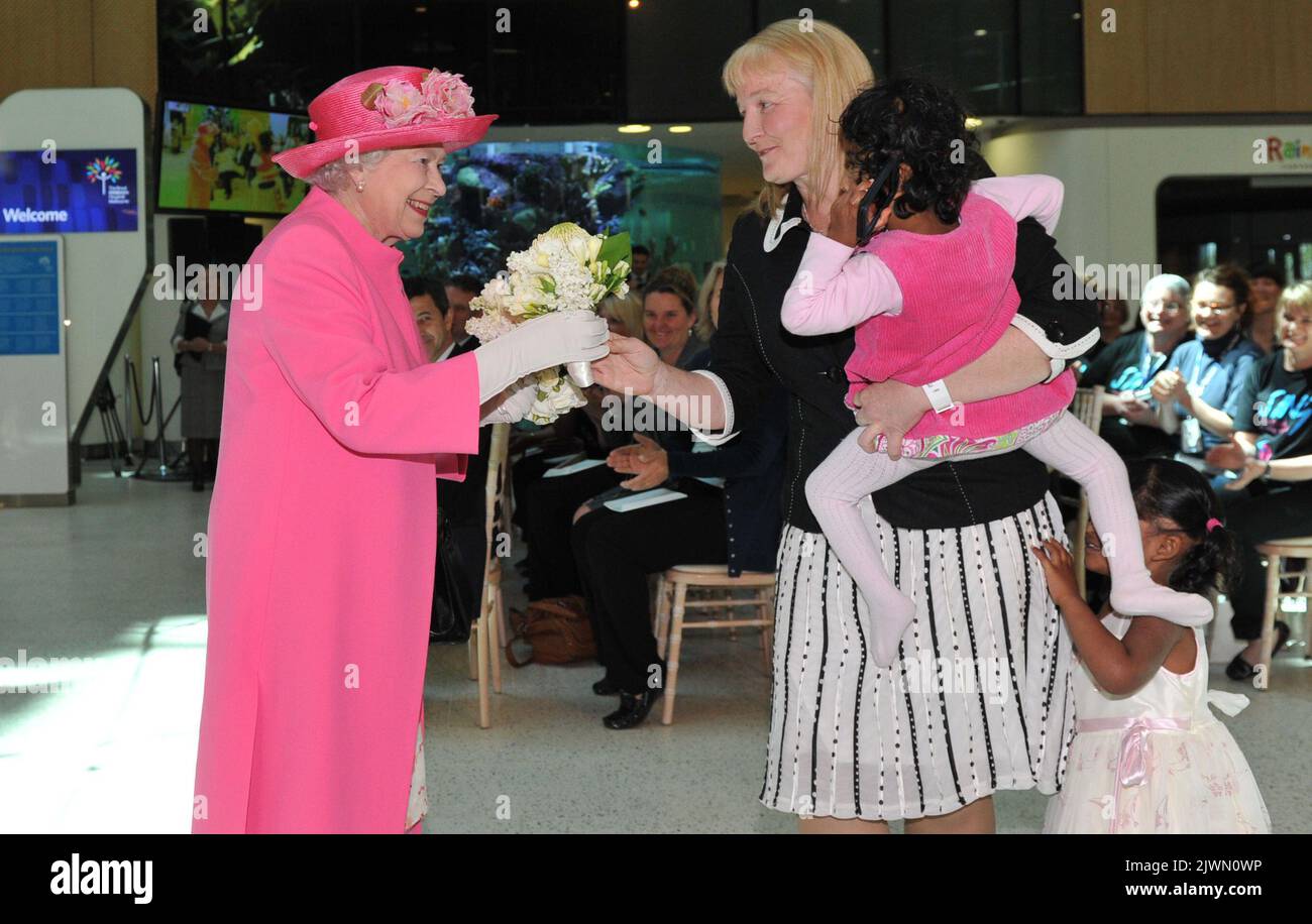 HRH Queen Elizabeth receives flowers from Miora Kelly as she holds ...