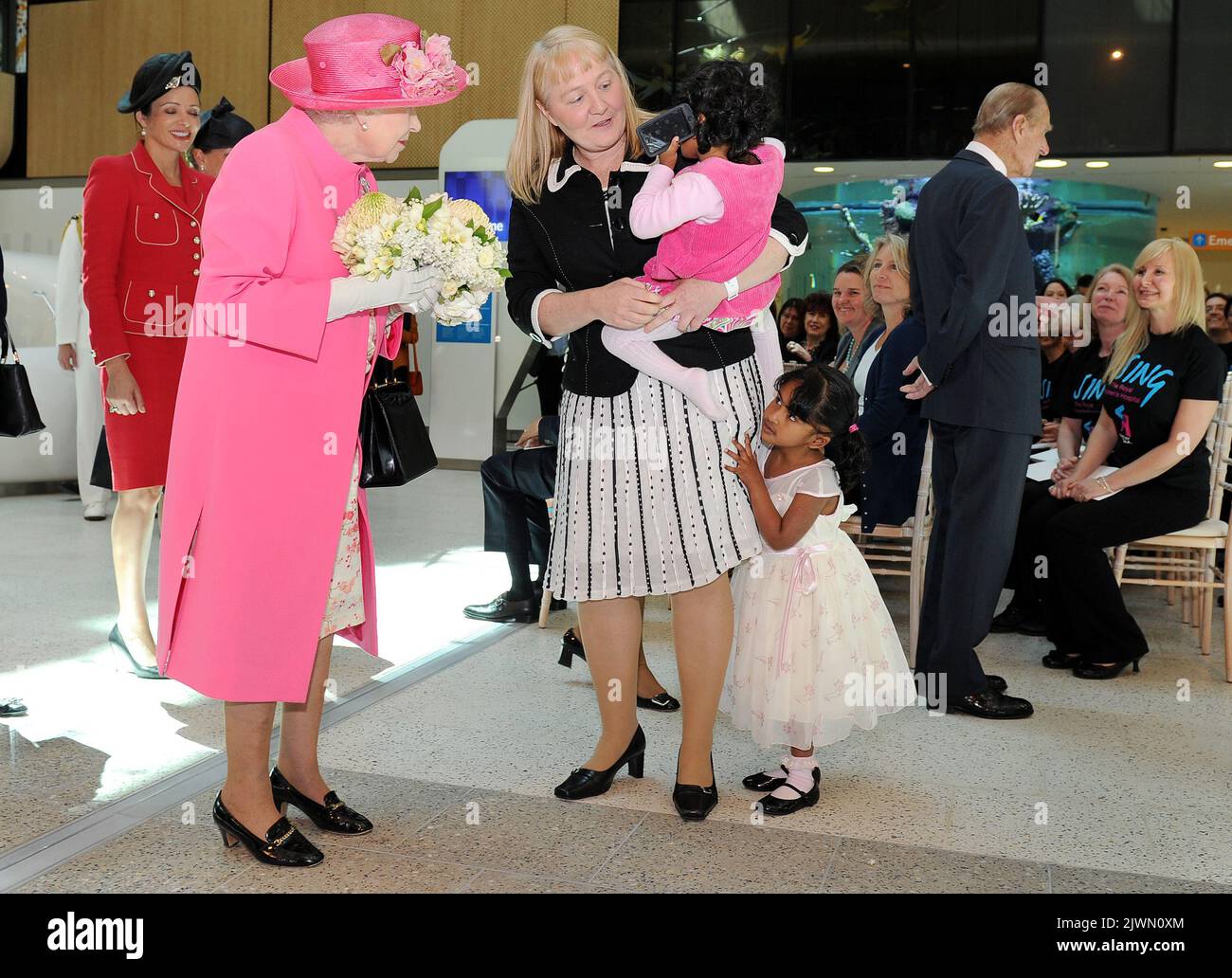 Britain's Queen Elizabeth II (2/L) talks with with Moira Kelly (C ...
