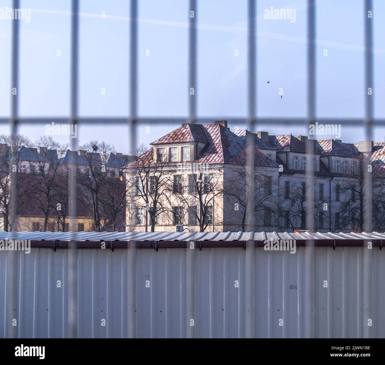 View of the building behind metal bars Stock Photo - Alamy