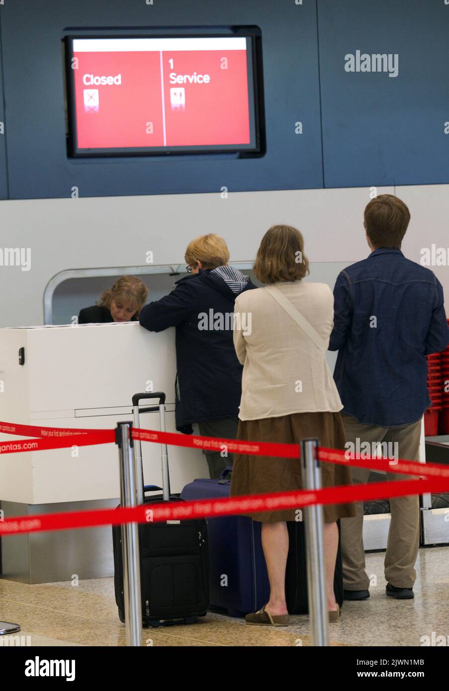 Passengers make enquiries at the Qantas check in desk at Melbourne's ...
