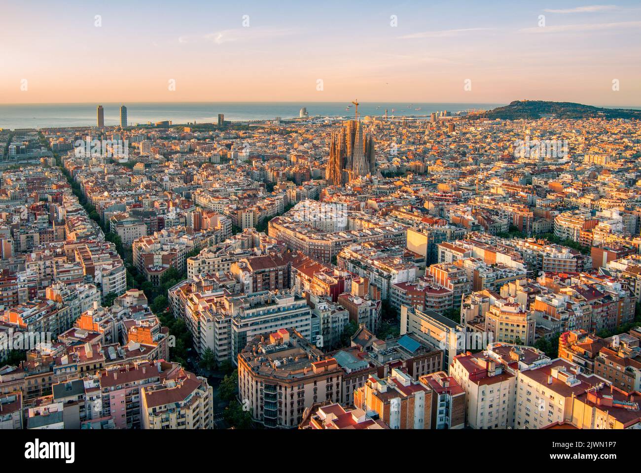 Aerial view of Barcelona Eixample residential district and Sagrada Familia Basilica at sunrise ...