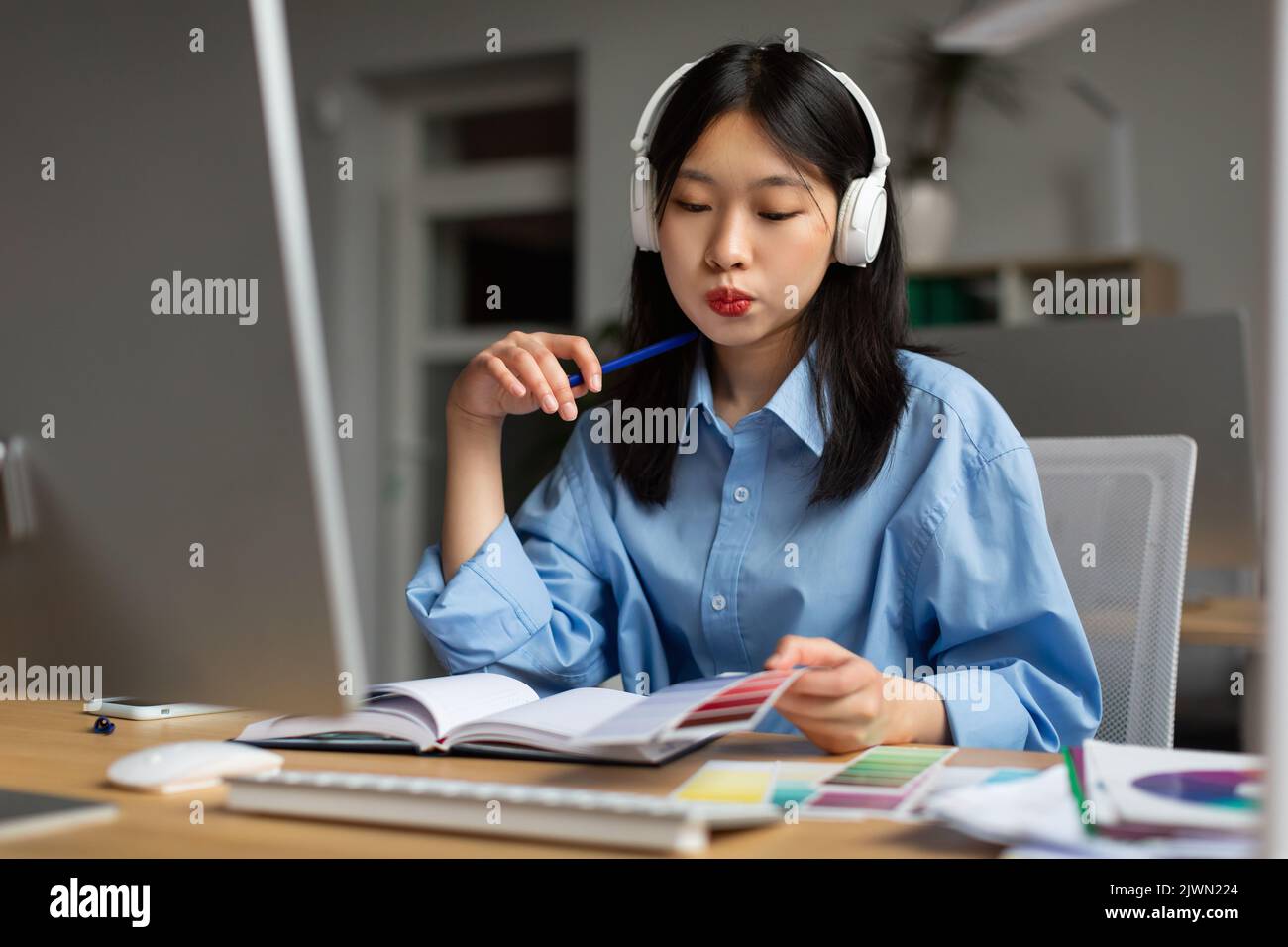 Korean Lady Designer Working With Color Palettes Near Computer Indoor ...