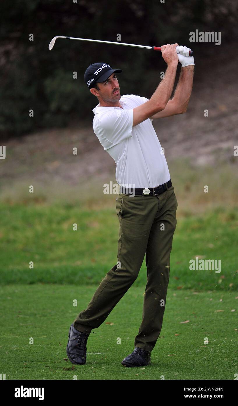 Australian golfer Geoff Ogilvy hits a shot on the 10th hole on day 1 of ...