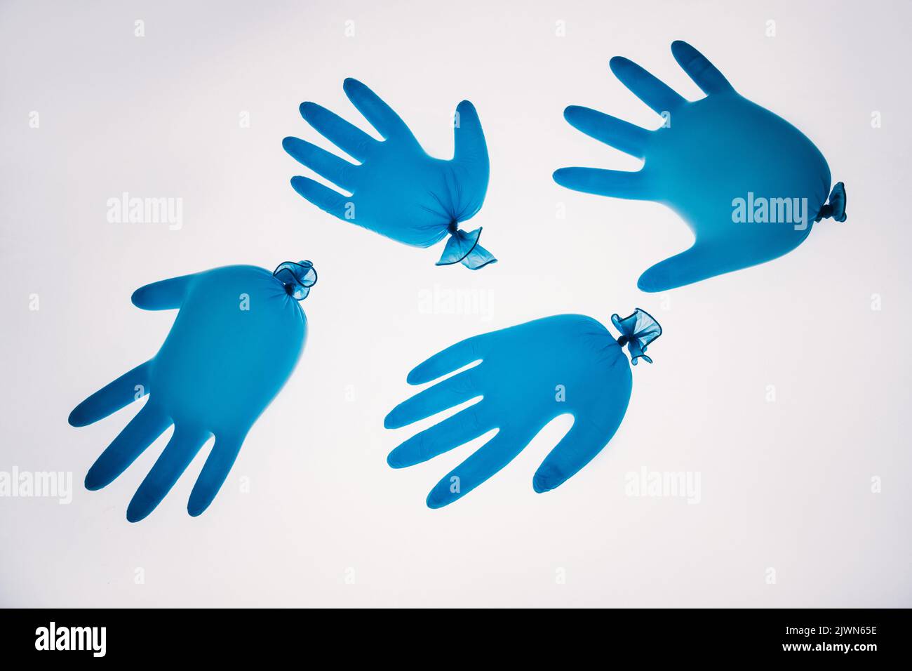 covid-19 art pandemic over blue blown blue gloves Stock Photo - Alamy