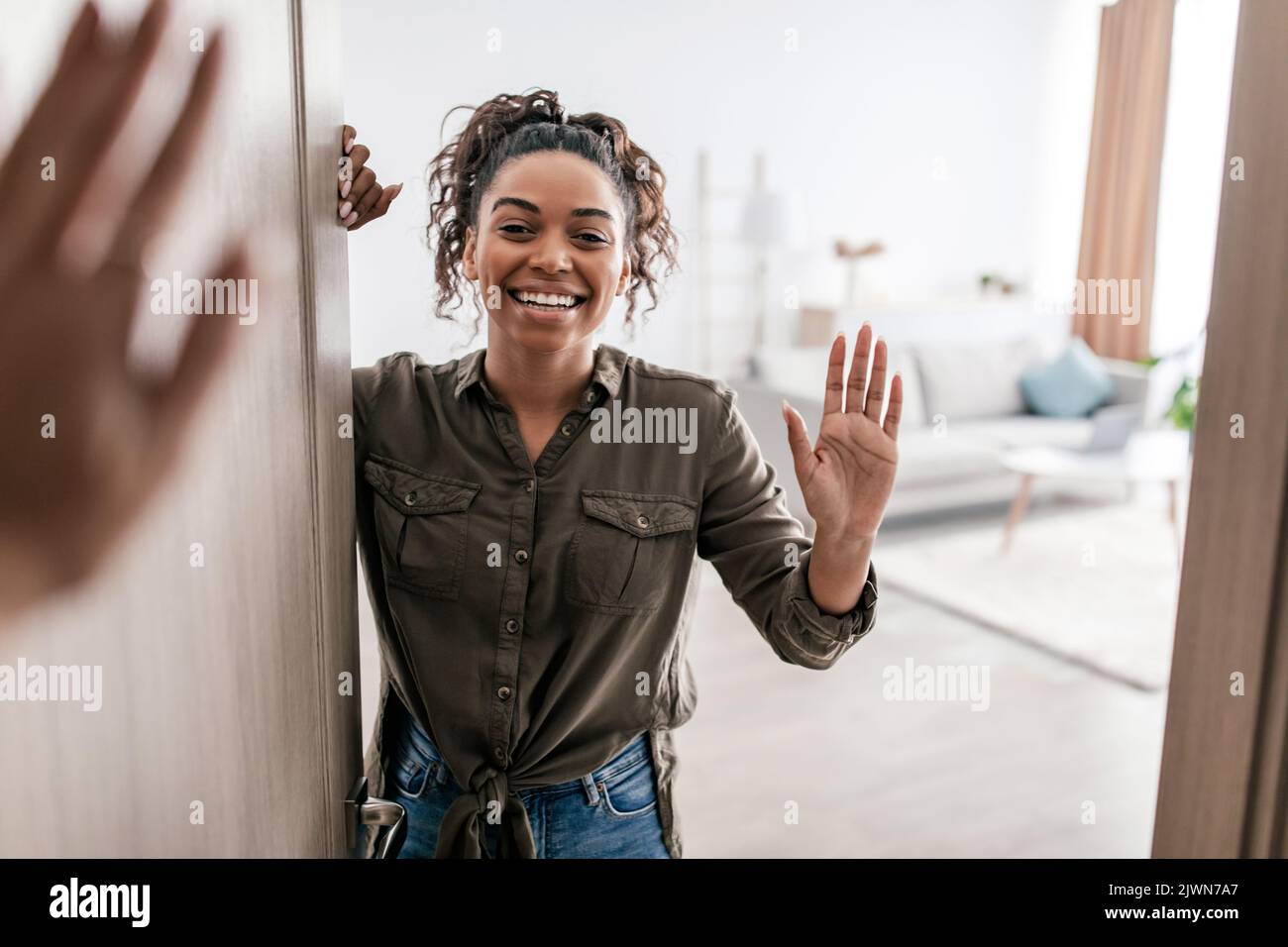 Happy African American Lady Waving Hello Opening Door At Home Stock ...