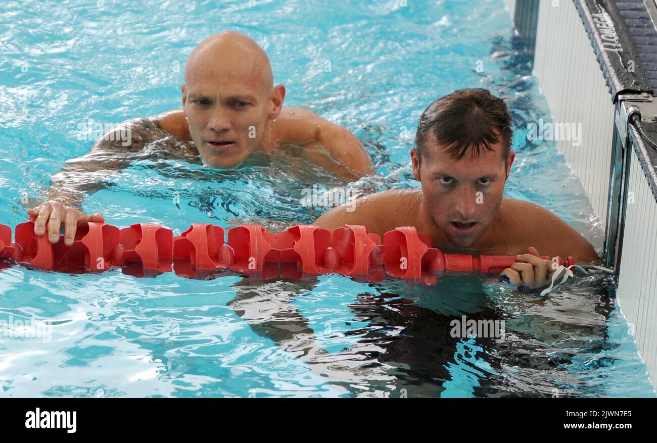 Michael Klim reacts with Ian Thorpe while leaving the pool after ...