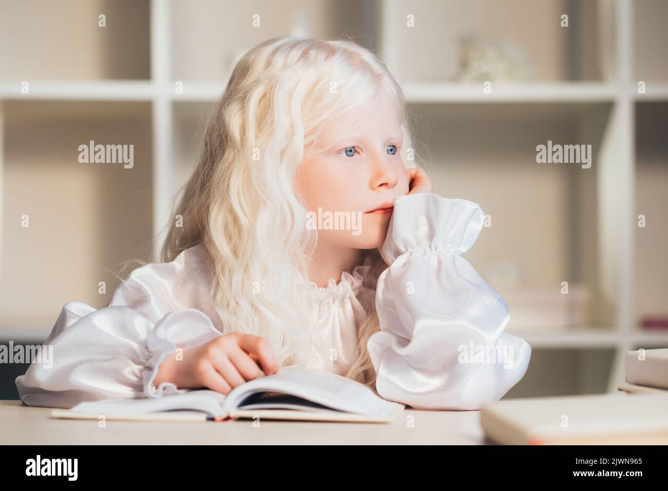 home learning child self-isolation bored girl book Stock Photo - Alamy