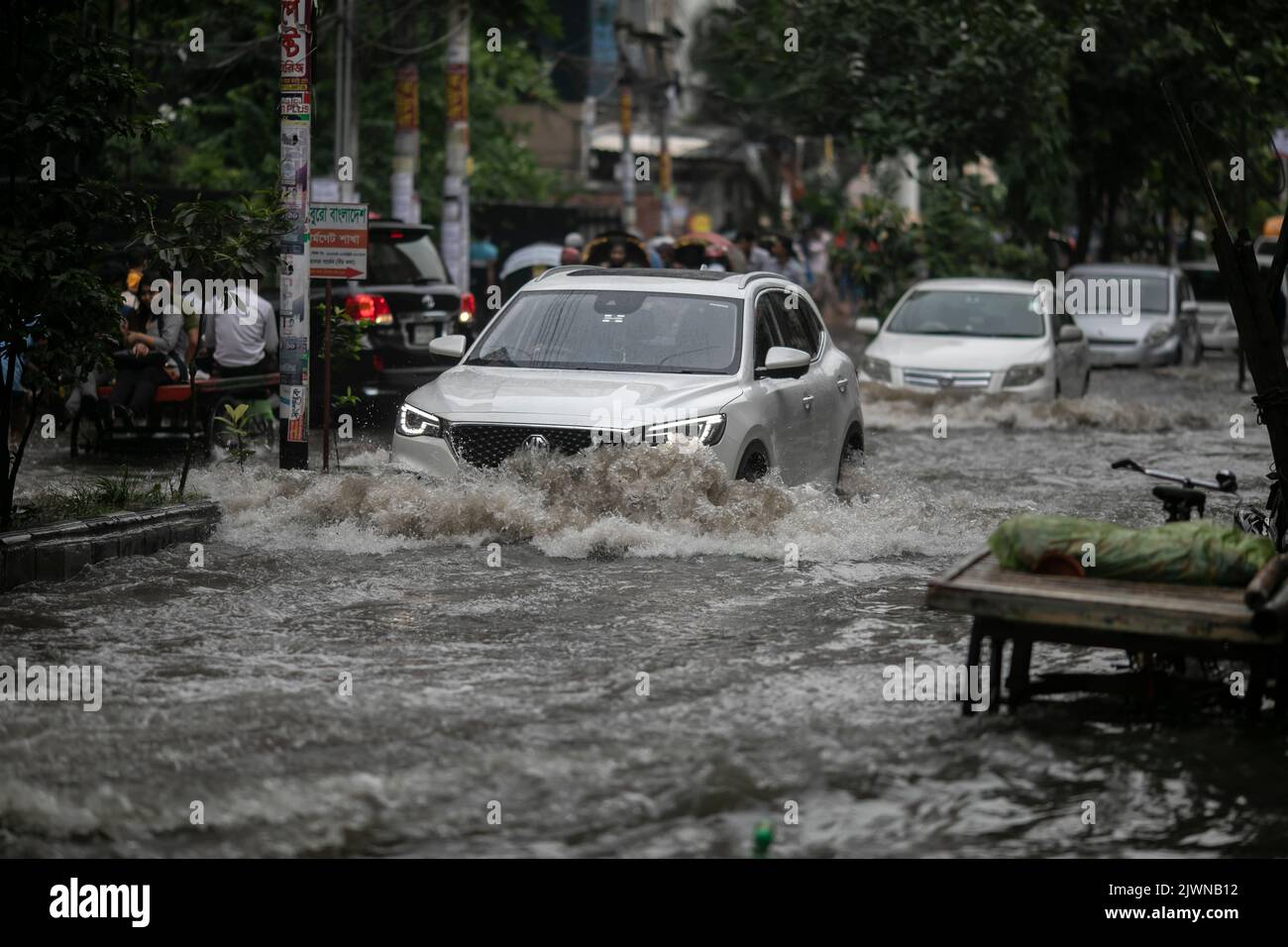 Vehicles drive through the waterlogged Green Road after heavy monsoon ...