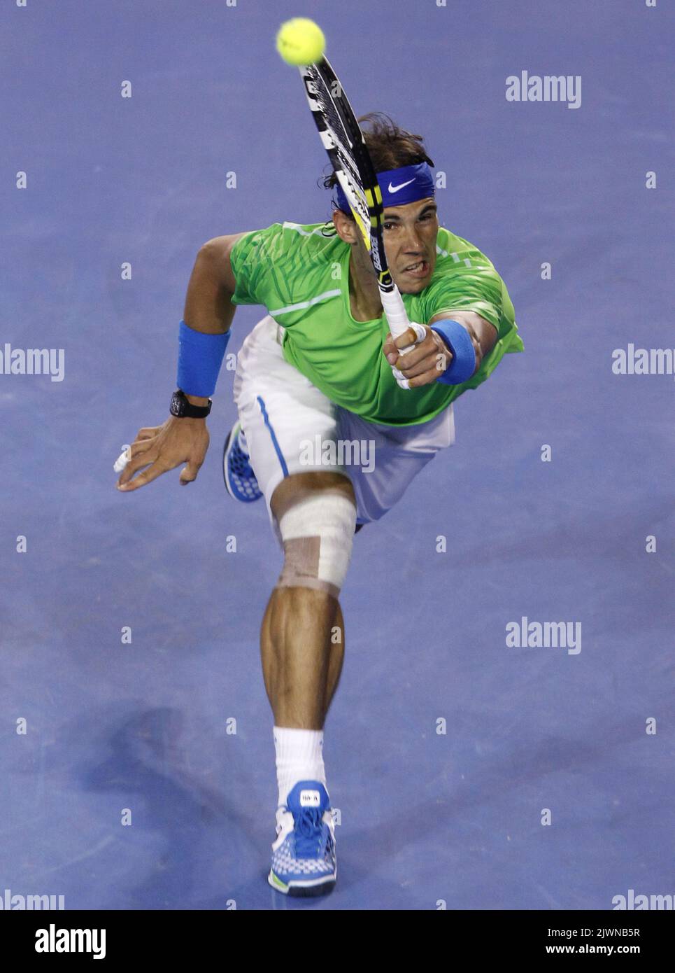Rafael Nadal of Spain returns to Roger Federer of Switzerland in their ...