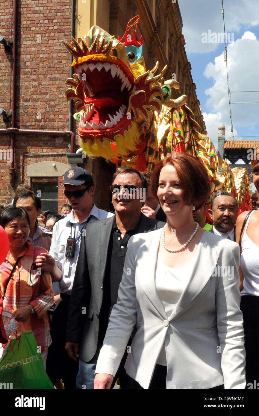 Prime Minister Julia Gillard and partner Tim Mathieson are followed by ...