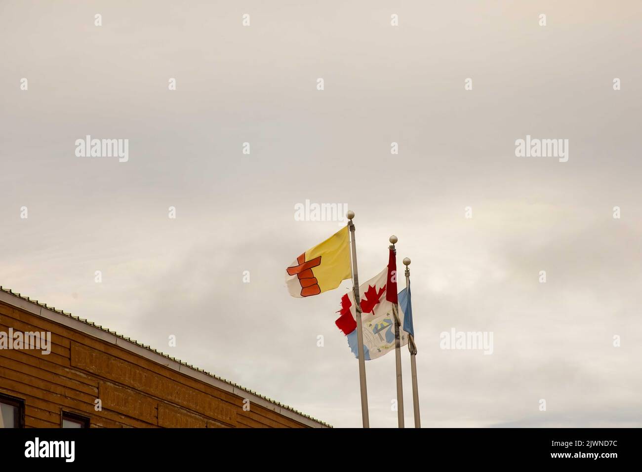 Flag of new Nunavut Territory next to Canadian flag and Cambridge Bay ...