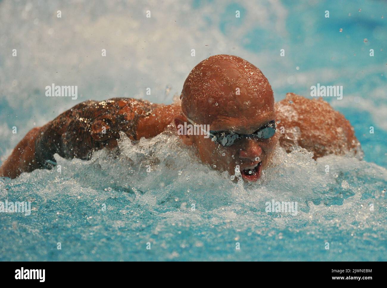 Michael Klim competes in the men's 100 metre butterfly final at the NSW ...