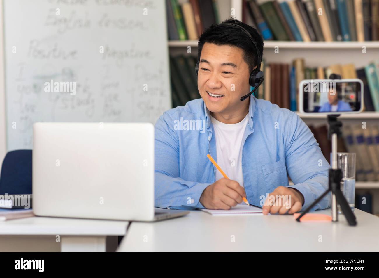 Cheerful Asian Teacher Male Teaching Having Online Lecture At Workplace ...