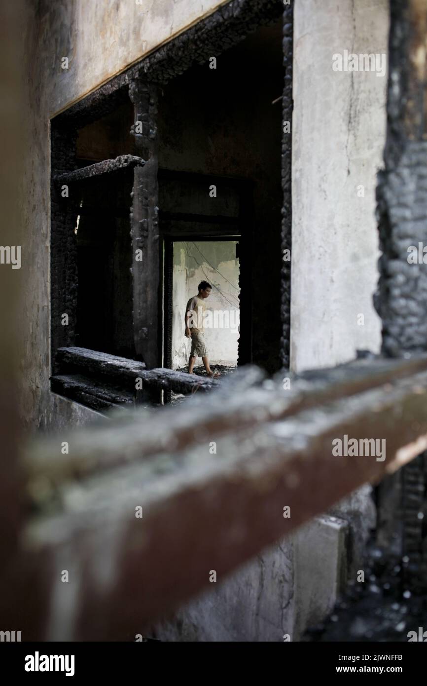 Inmate walks near burnt ruins after the rioting last night inside ...