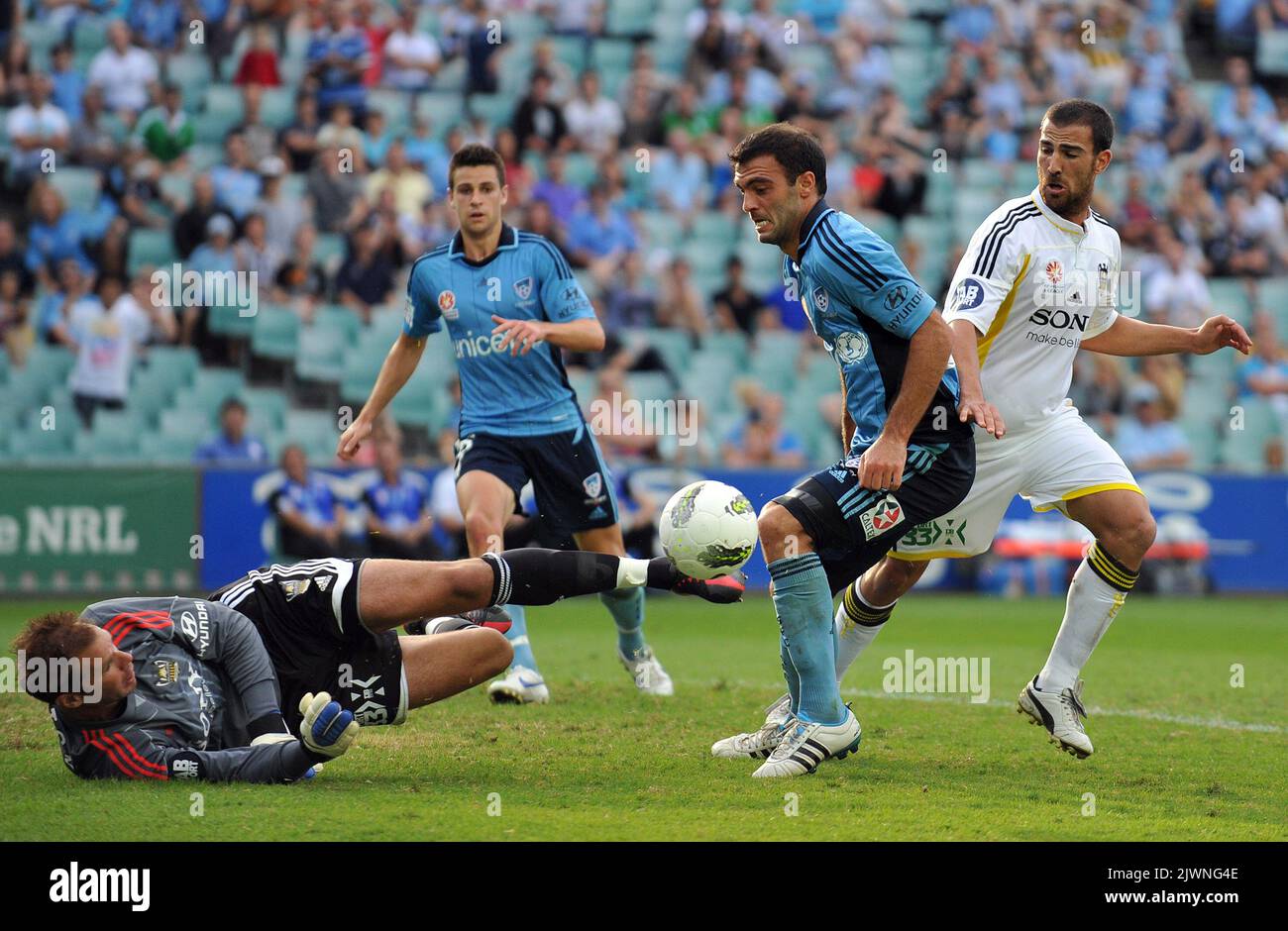 Wellington Phoenix FC's Mark Paston (left) saves a shot at goal by ...