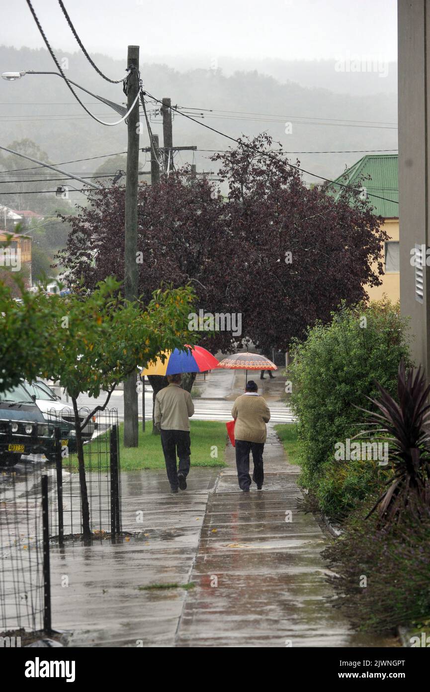 Residents walk in the rain in Cooma, Thursday, March. 1, 2012 ...