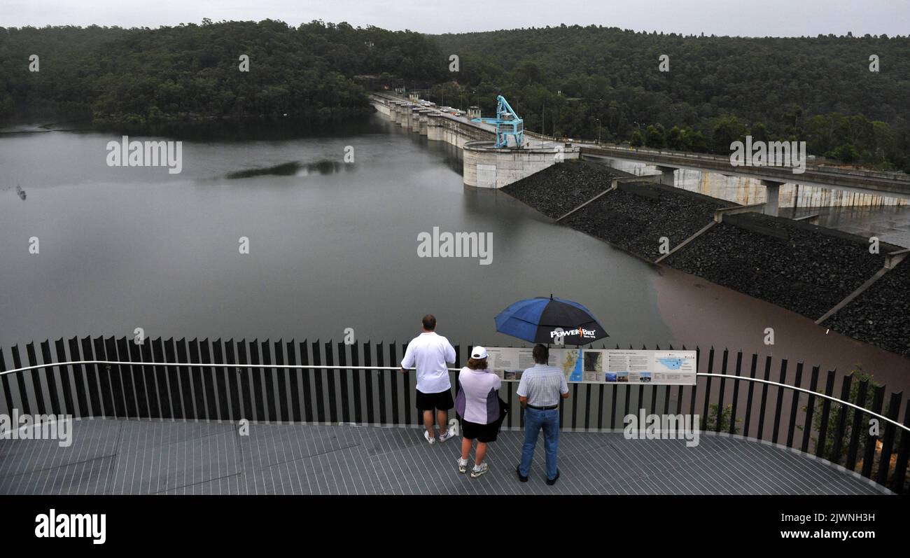 Members of the public look on at a swollen Warragamba Dam in Sydney's ...