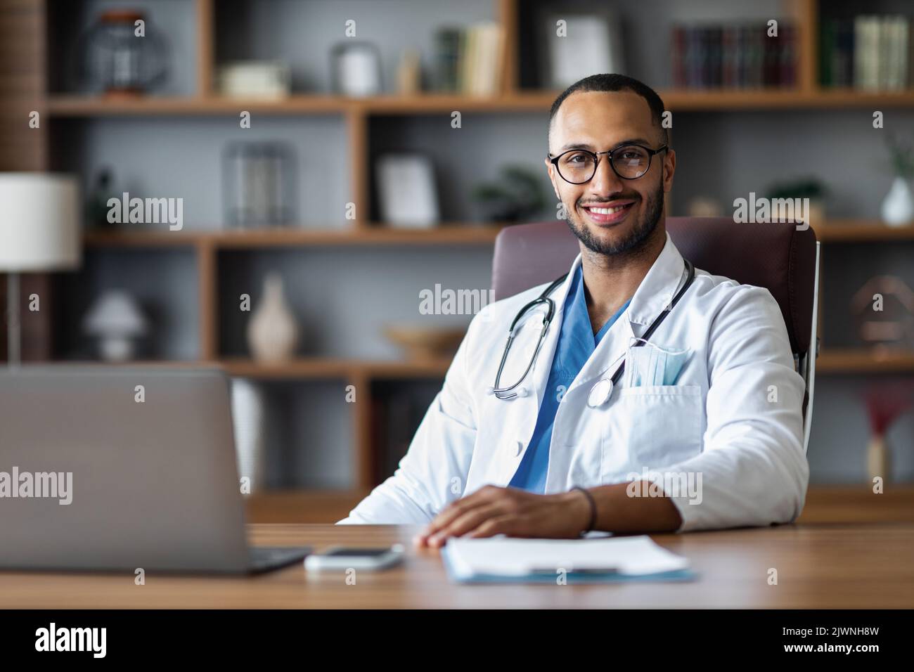 Handsome hospital doctor writing hi-res stock photography and images ...