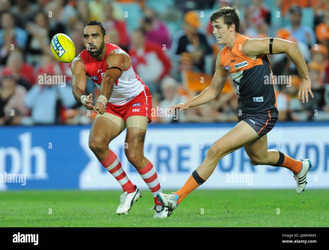 The Sydney Swans Adam Goodes gets a hand ball away despite pressure ...
