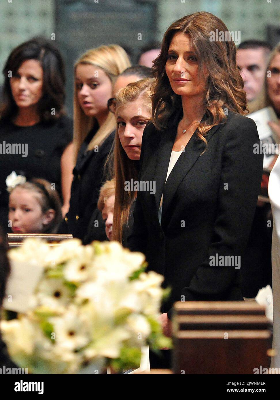 Jim Stynes' daughter Matisse and wife Sam look on as his coffin comes ...