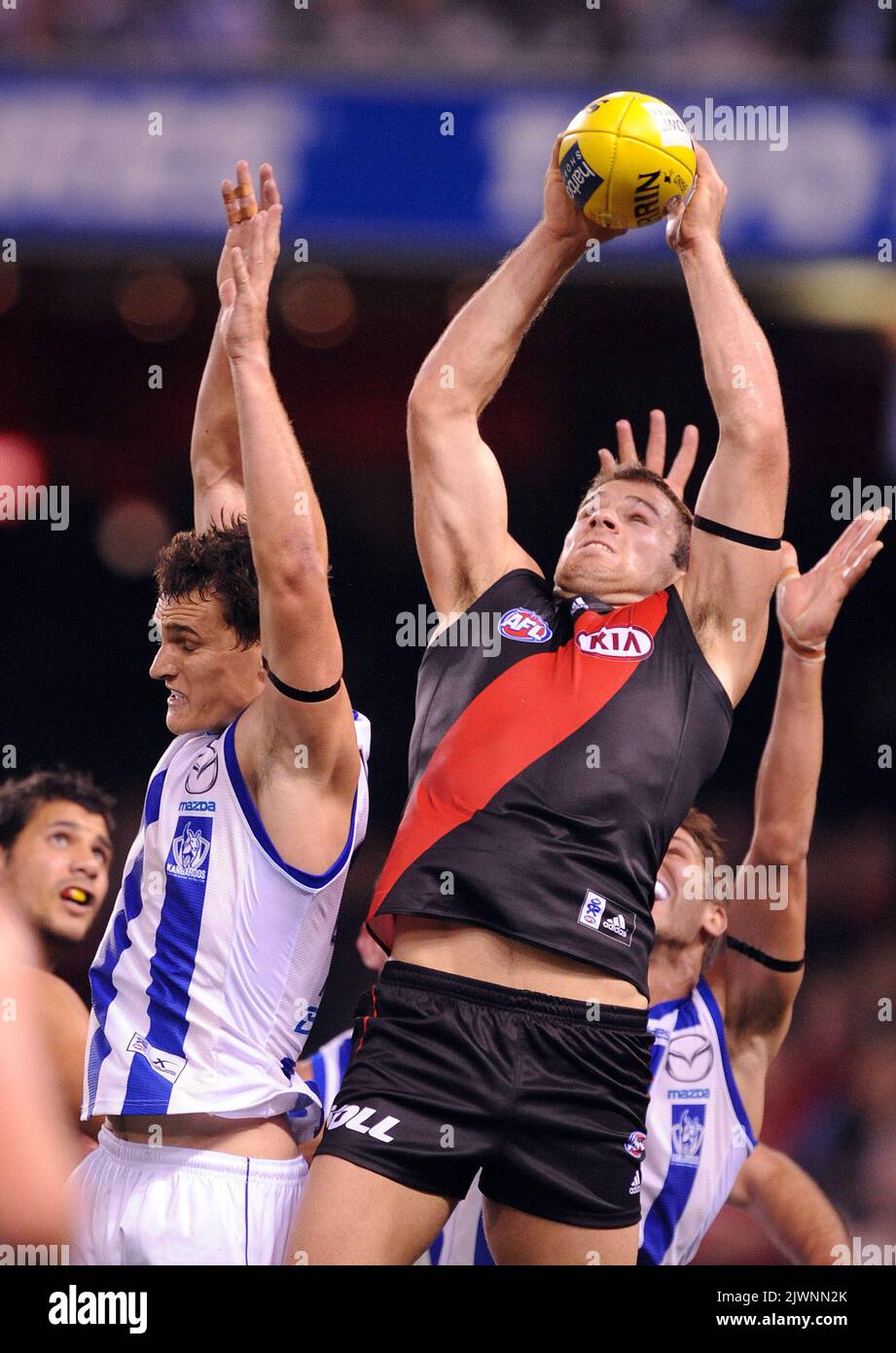 Stewart Crameri of Essendon marks ahead of Scott Thompson of North ...