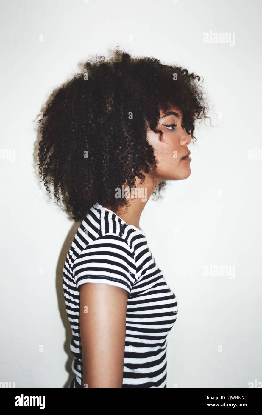 The profile of curly perfection. Profile of an attractive young woman ...