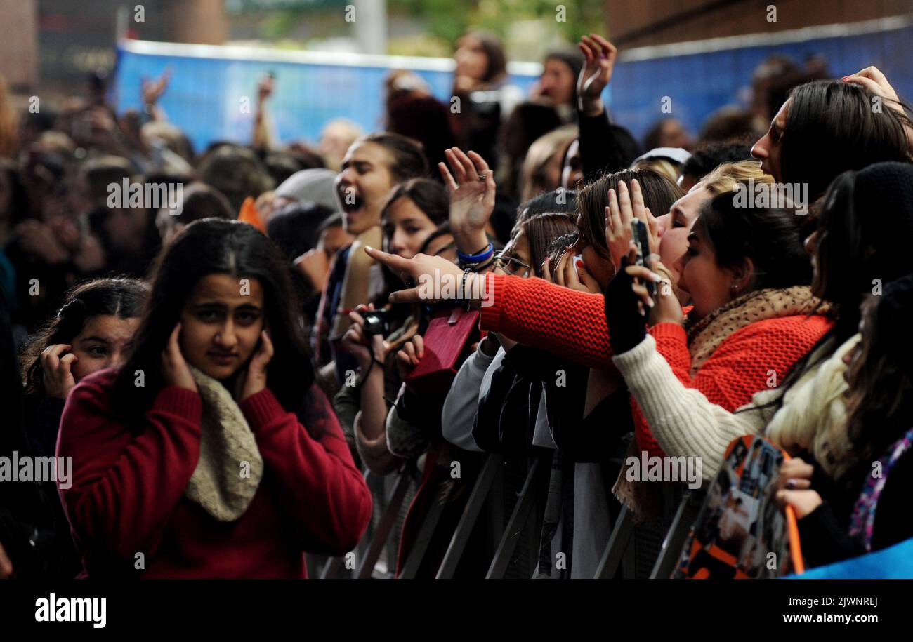 Screaming and crying fans of British boy band One Direction try and ...