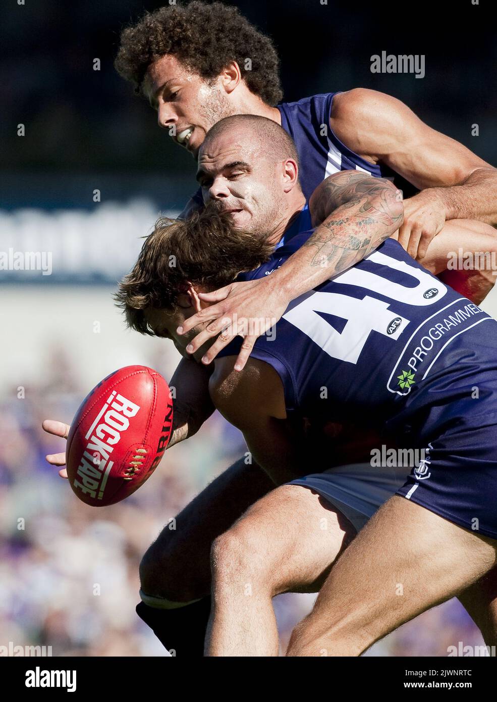 Ashley McGrath for Brisbane is stopped by Zac Clarke for Fremantle ...