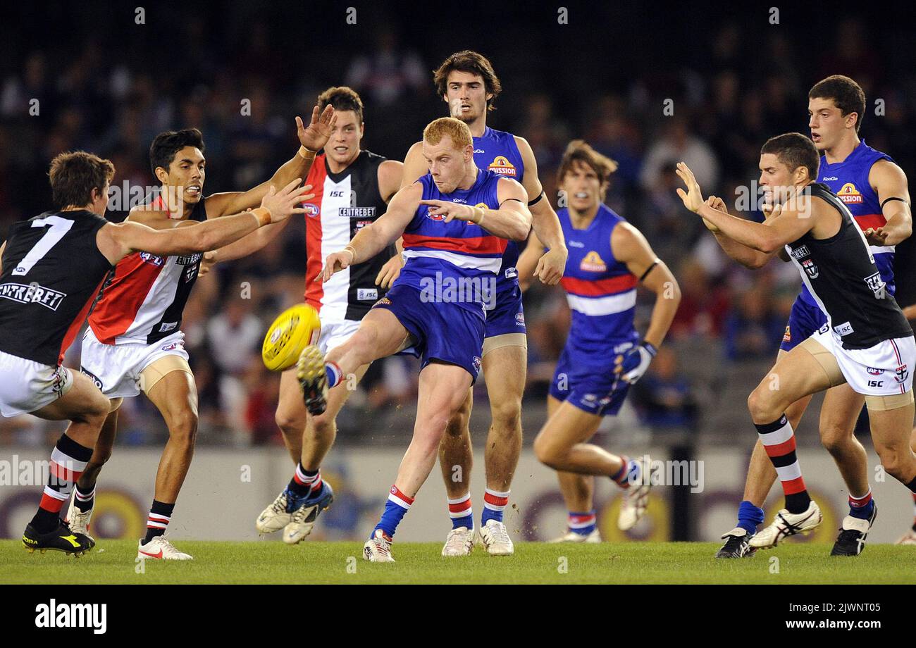 Adam Cooney of the Western Bulldogs clears the ball from the centre ...