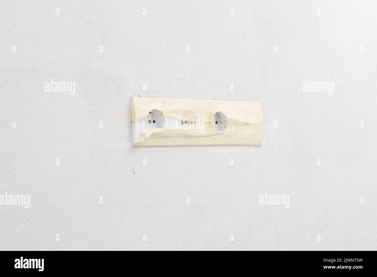 White sockets on a white wall, a socket for a TV antenna, sockets with ...