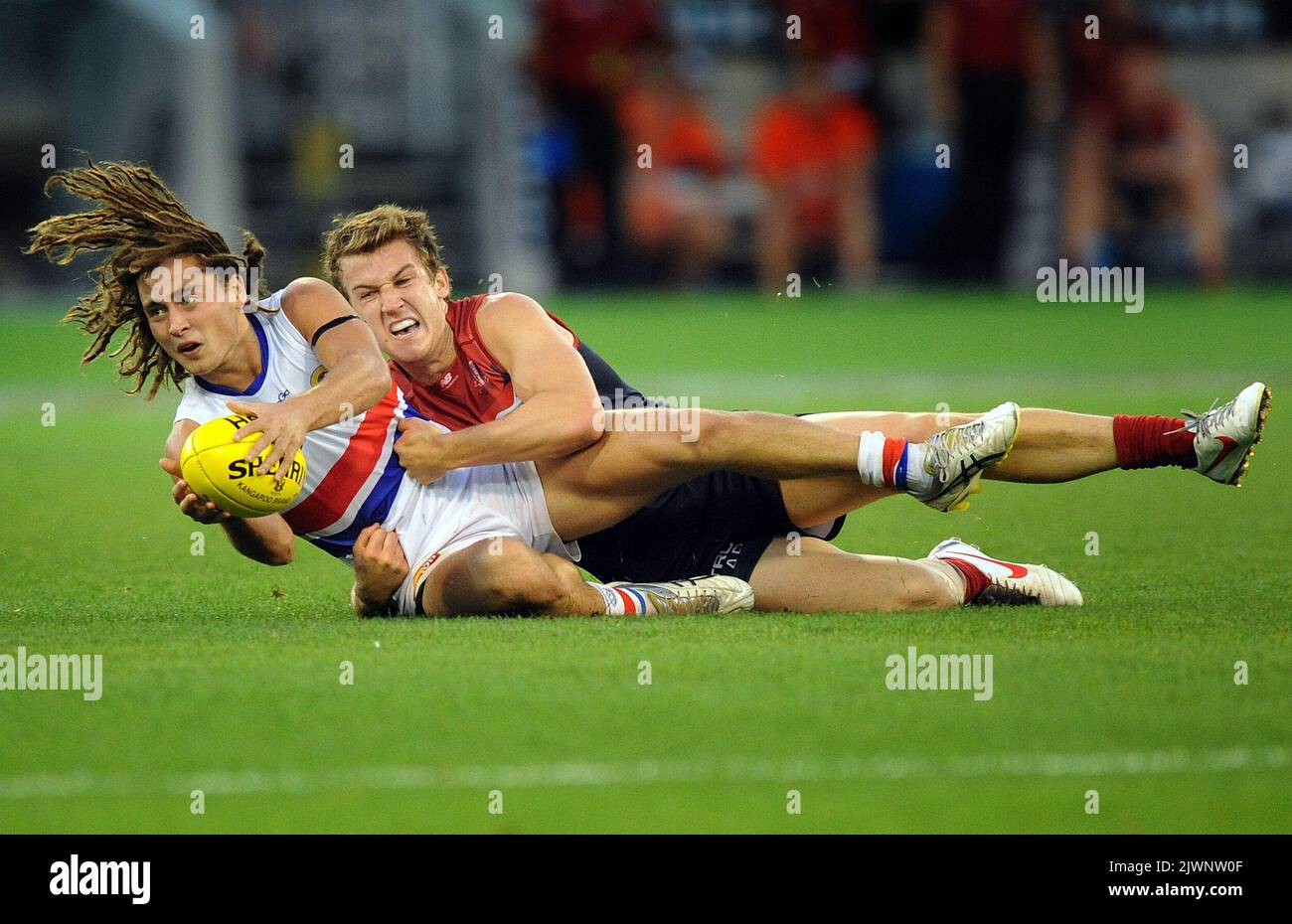 Jack Trengove of Melbourne tackles Luke Dahlhus of the Western Bulldogs ...