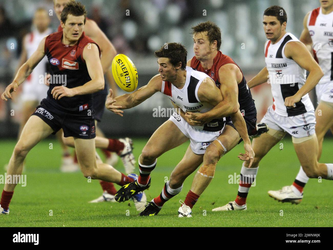 Lenny Hayes of St Kilda and Clint Bartram of Melbourne in action during ...