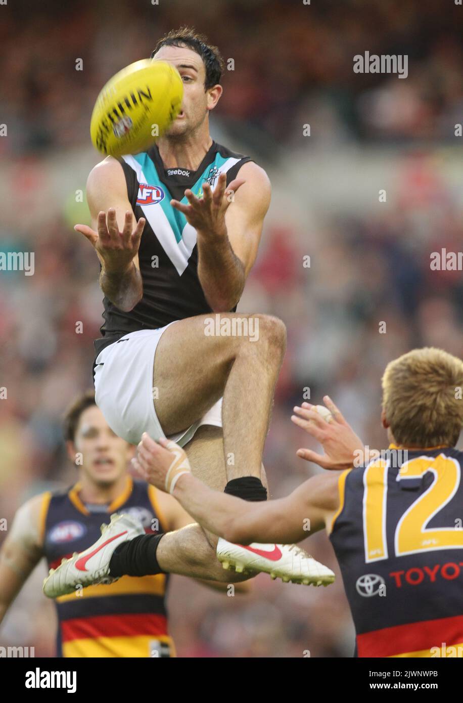 Matthew Broadbent of Port Adelaide takes a mark in front of Daniel ...