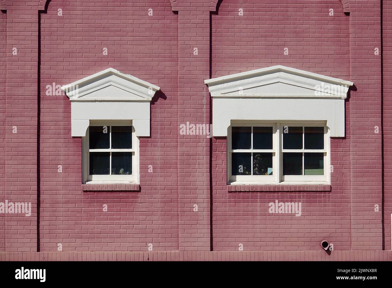architectural details of white trimmed windows on red brick building ...