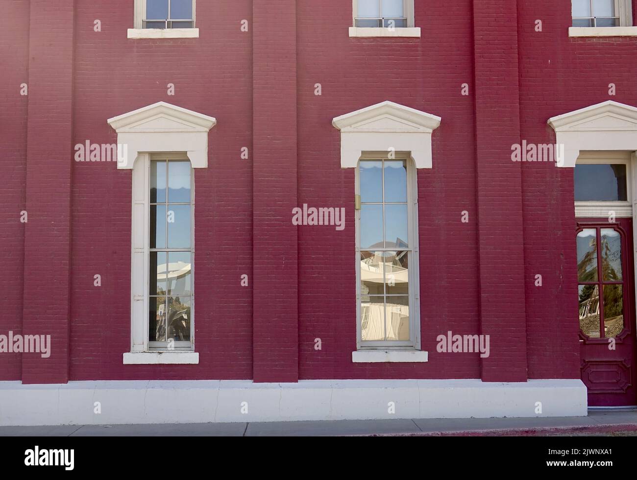 Historic old brick building with rectangular windows trimmed in white ...