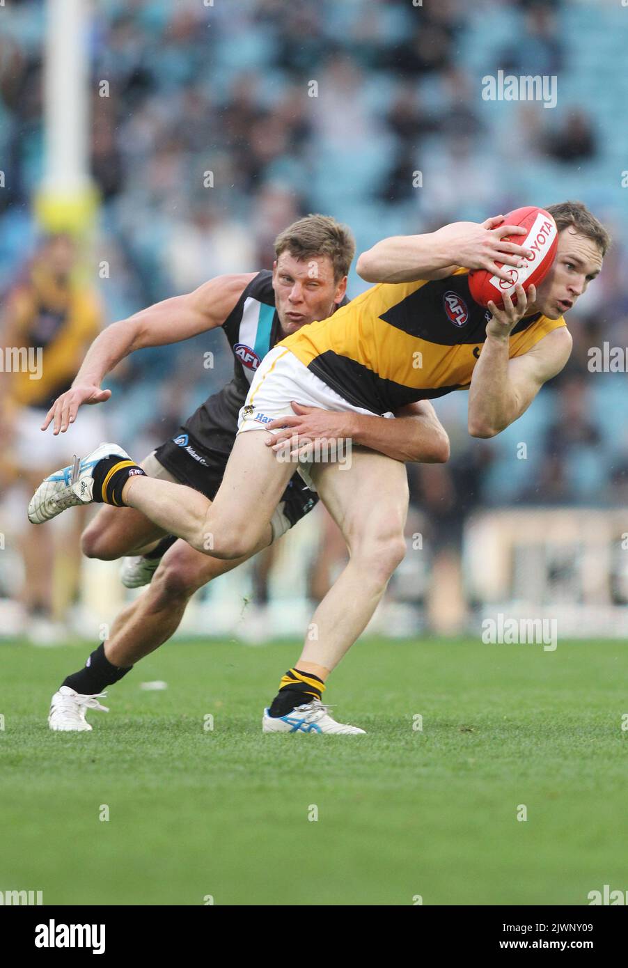 Jake Batchelor of the Richmond Tigers is tackled by Bradley Ebert of Port Adelaide during round ...