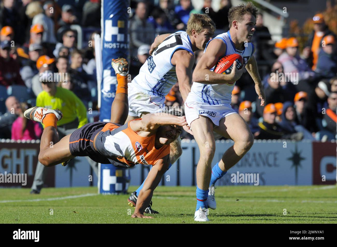 The Greater Western Sydney Giants' Israel Folau (center) tackles Gold ...