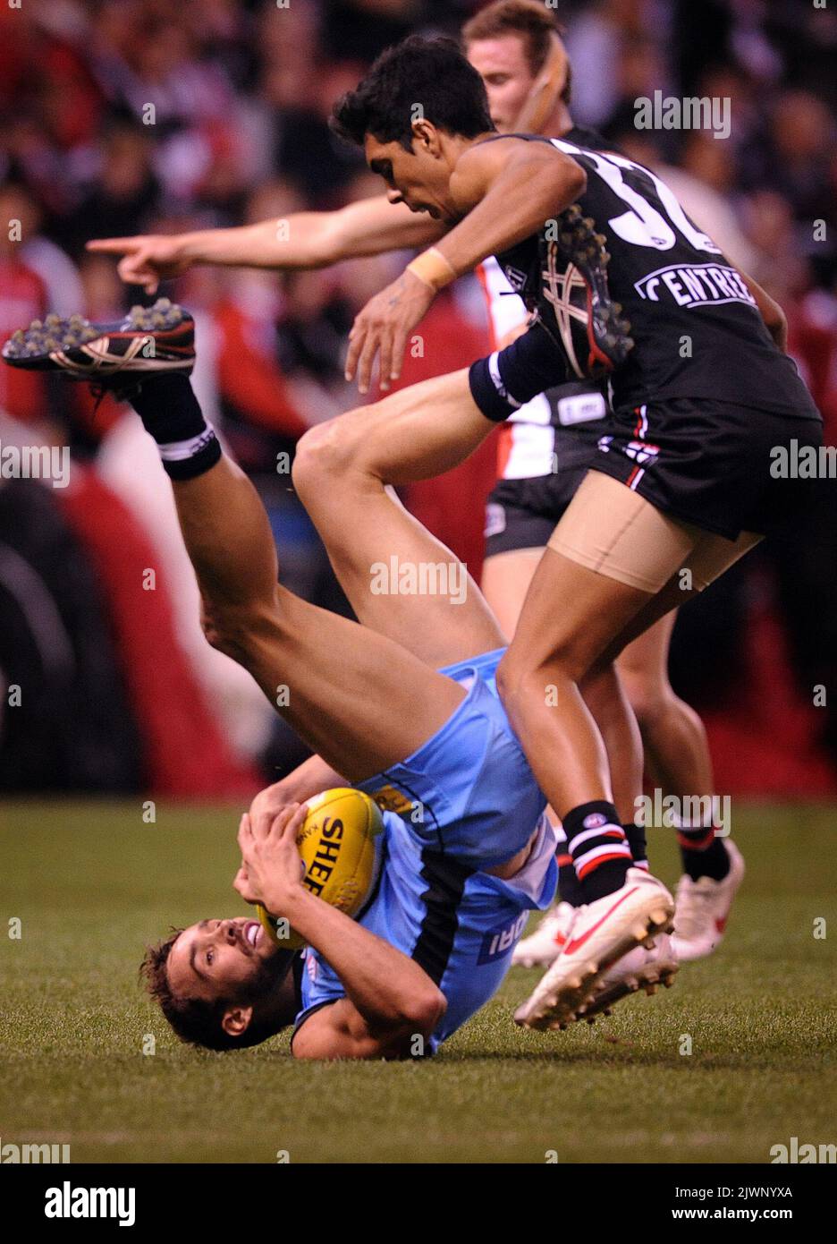 Terry Milera of St Kilda looks over Andrew Walker of Carlton, during ...