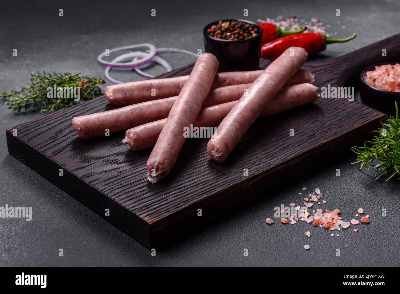 Raw sausages and ingredients for cooking. Top view with copy space on ...