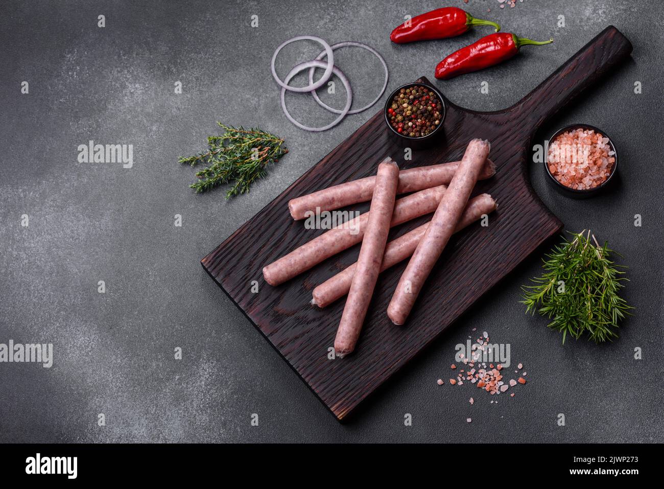 Raw sausages and ingredients for cooking. Top view with copy space on ...