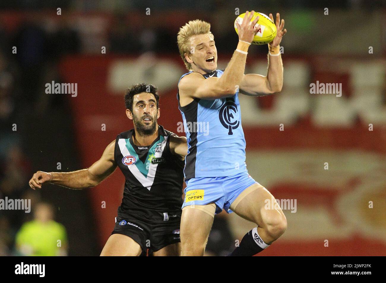 Dennis Armfield of Carlton takes a mark in front of Domenic Cassisi of ...