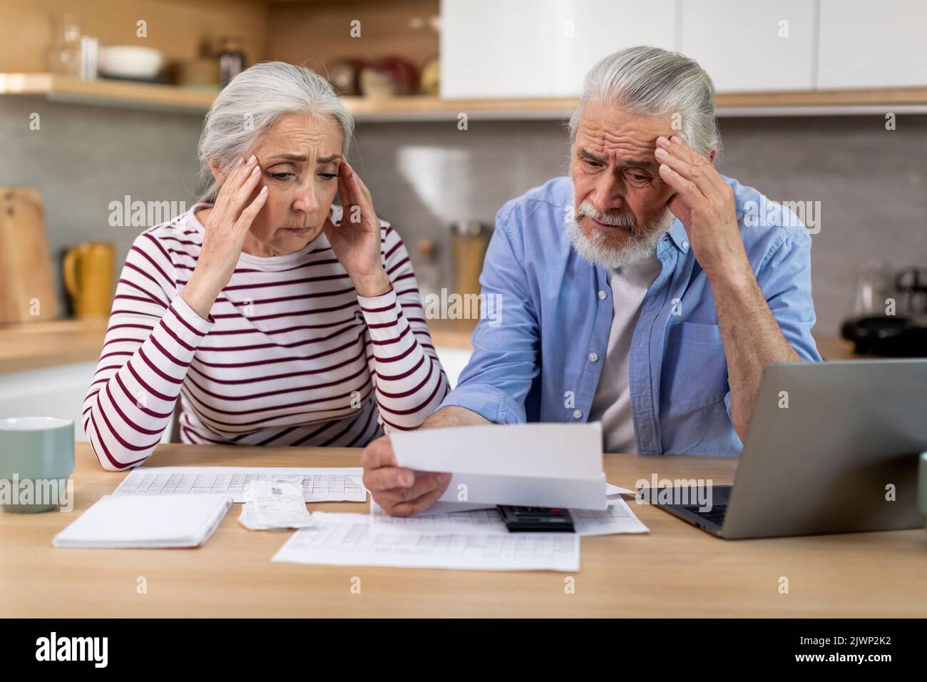 Stressed Senior Couple Checking Financial Papers And Planning Budget At ...