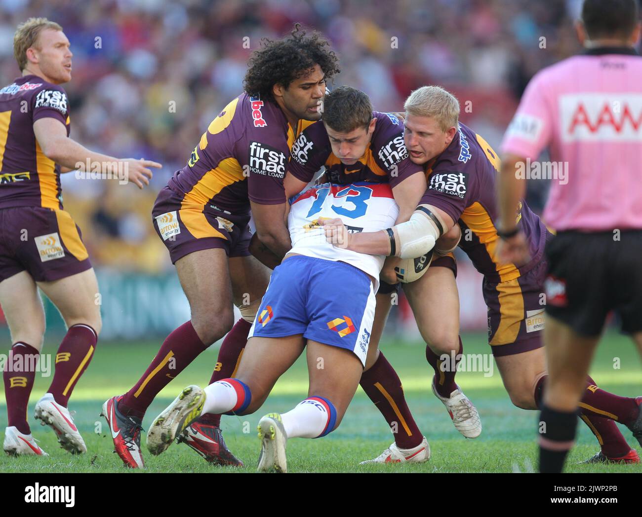Neville Costigan hits the wall of Sam Thaiday, Andrew McCullough and ...