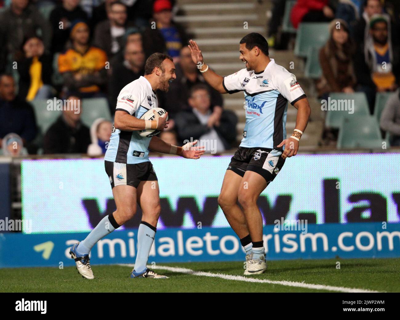 Isaac Gordon celebrates his try with Mark Taufua during the NRL Round ...