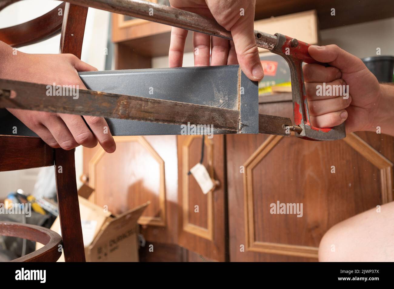 Trimming a wooden plinth with a hand jigsaw, hand tool jigsaw and ...