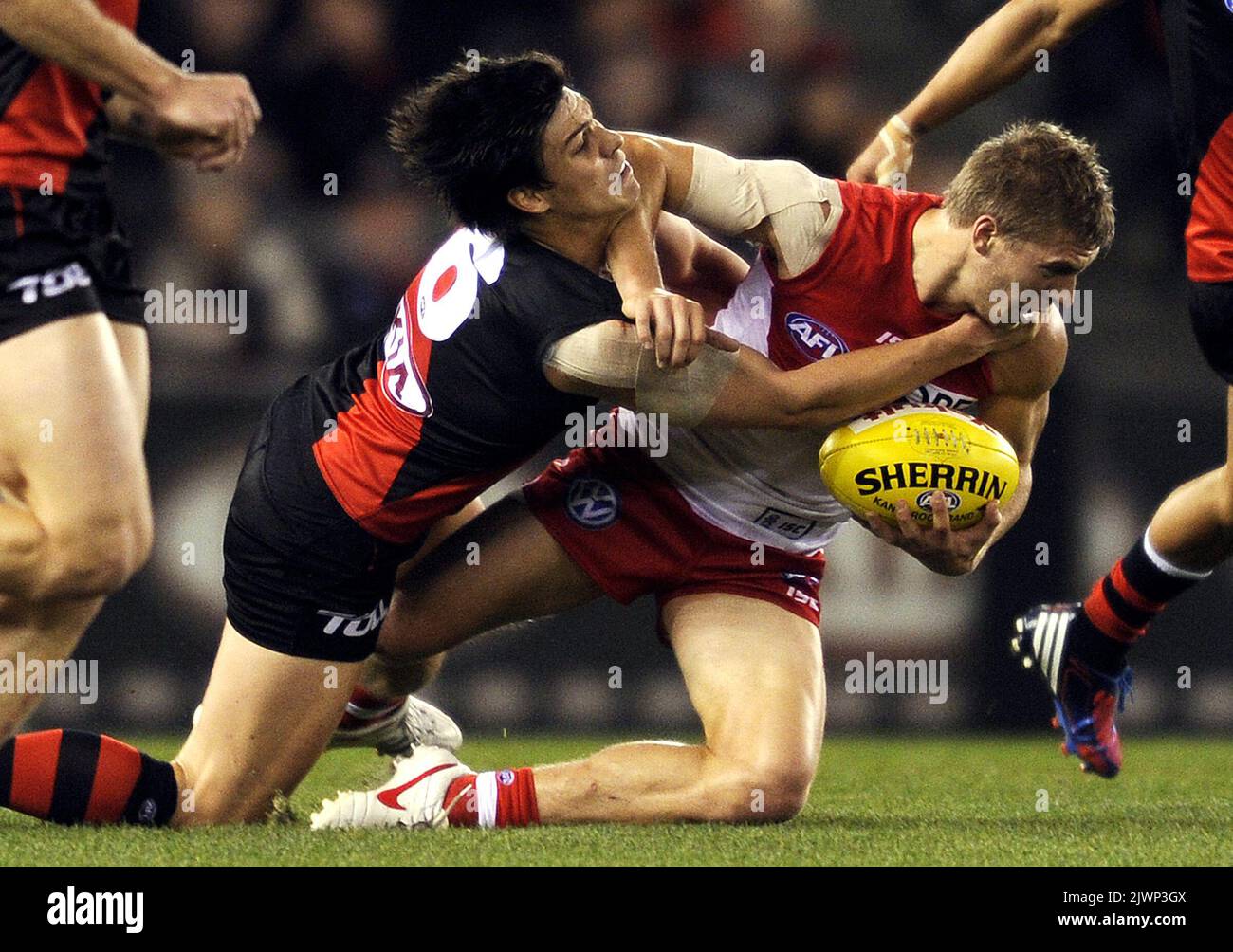 Angus Monfries of Essendon tackles Kieran Jack of Sydney during their ...