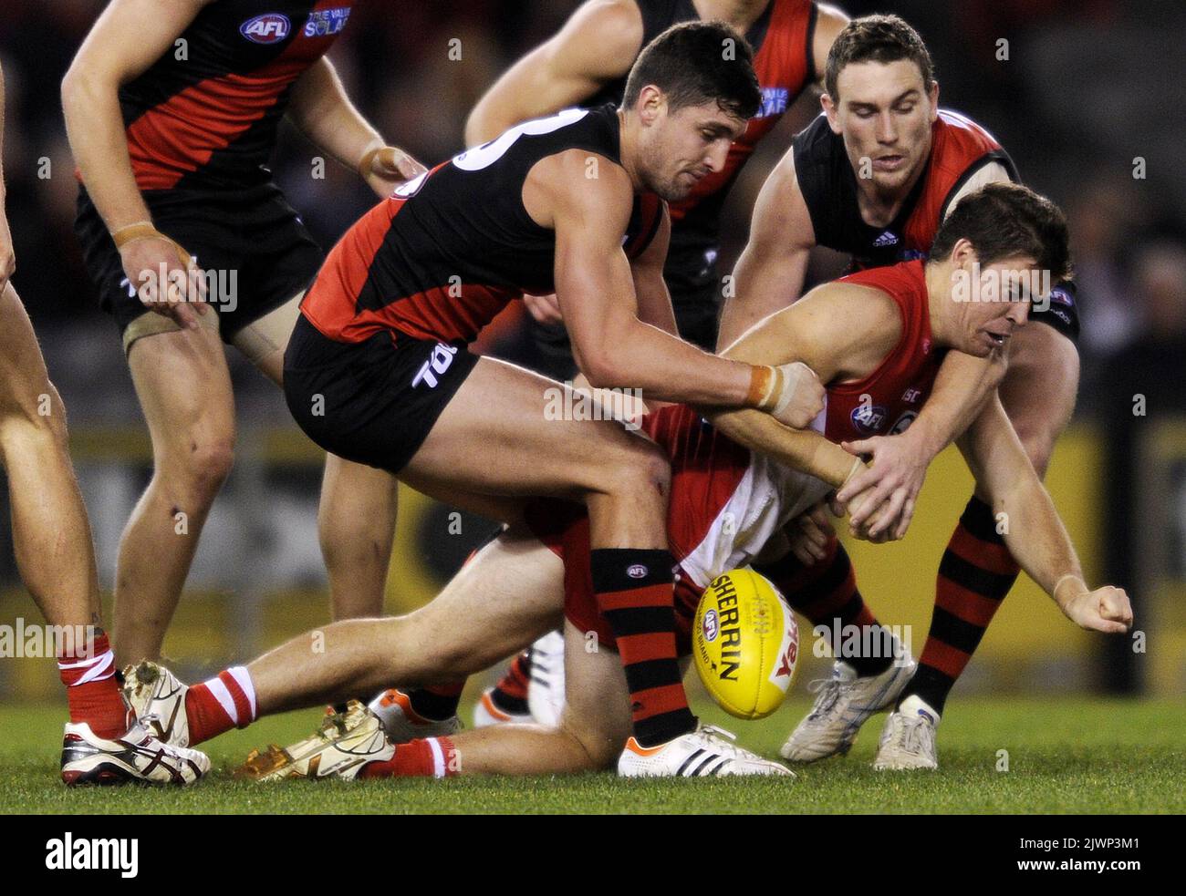 David Myers (L) and Heath Hocking (R) of Essendon tackle Craig Bird of ...