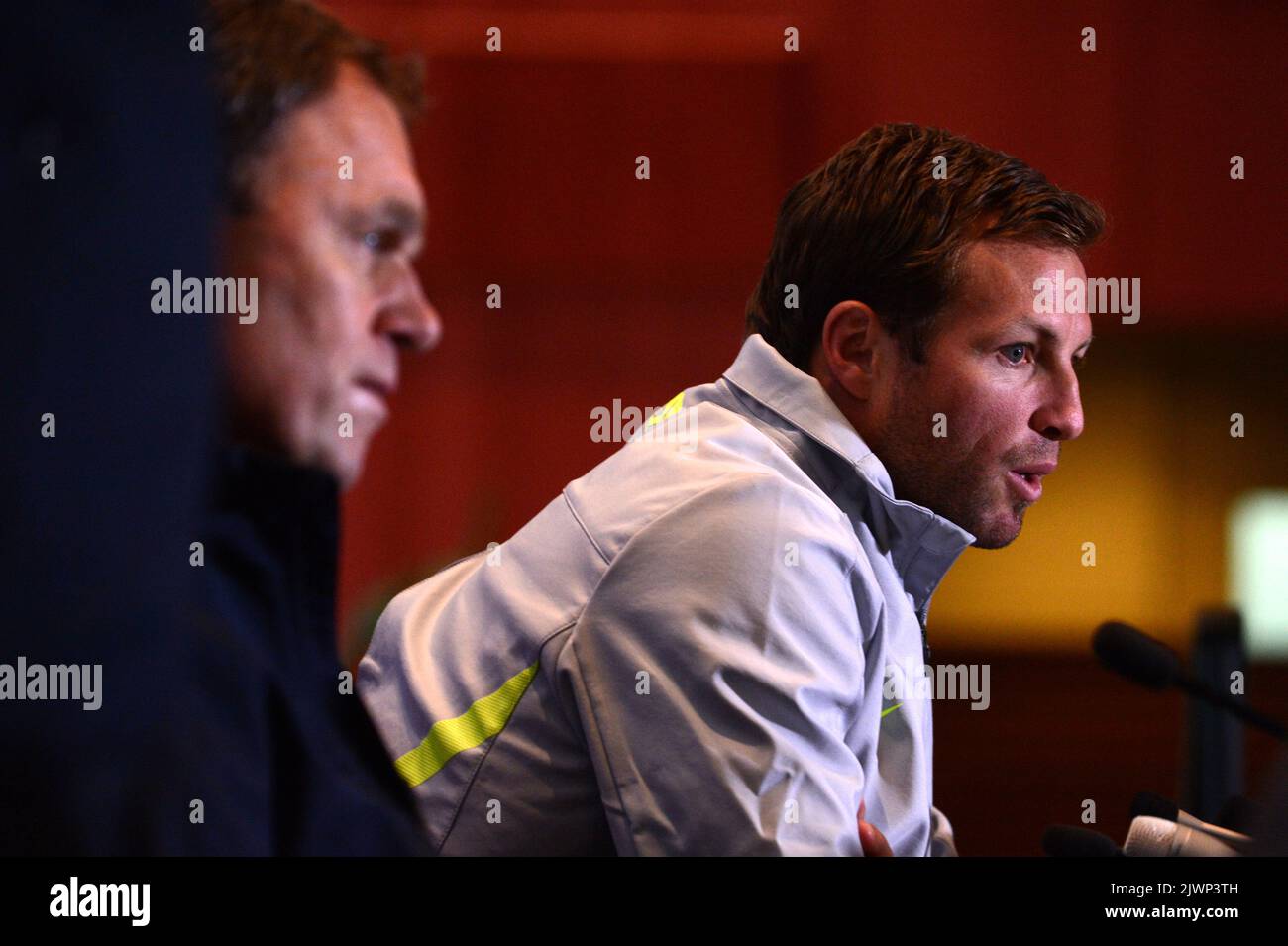 Socceroos coach Holger Osieck (left) and captain Lucas Neill speak to ...